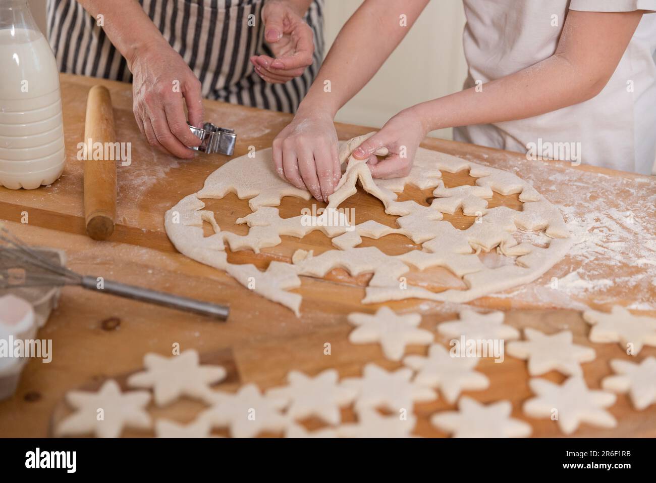 Family in kitchen. Grandmother granddaughter child hands cutting ...