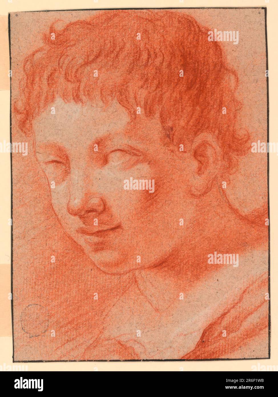 Slightly lowered head of a boy shown in three-quarter profile turned ...