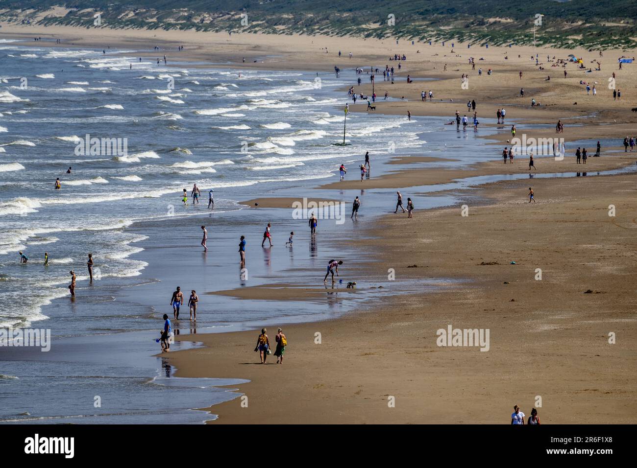 SCHEVENINGEN - Beachgoers enjoy the beautiful weather on the beach of ...