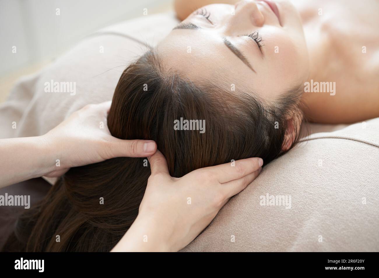 Woman receiving head massage in bright beauty salon Stock Photo - Alamy
