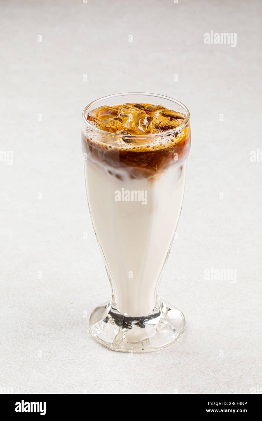 Glass of cold coffee with ice and milk Stock Photo - Alamy