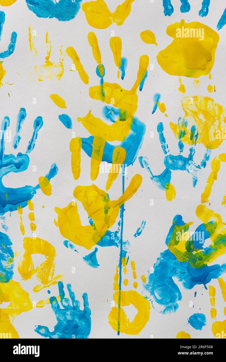 bright prints of children's hands from paint on the wall, background ...