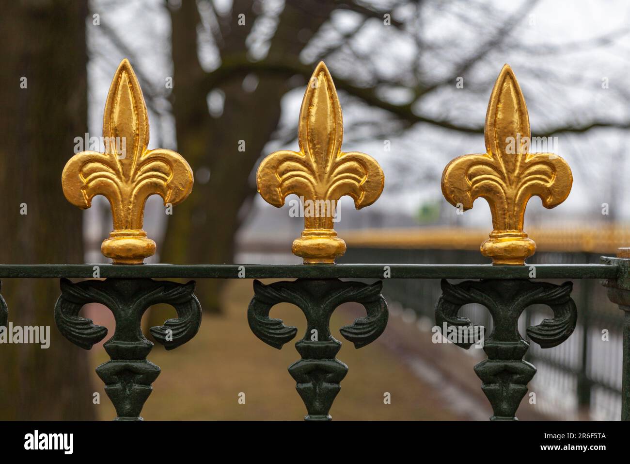 Antique wrought iron fence with gilded ornament Stock Photo - Alamy