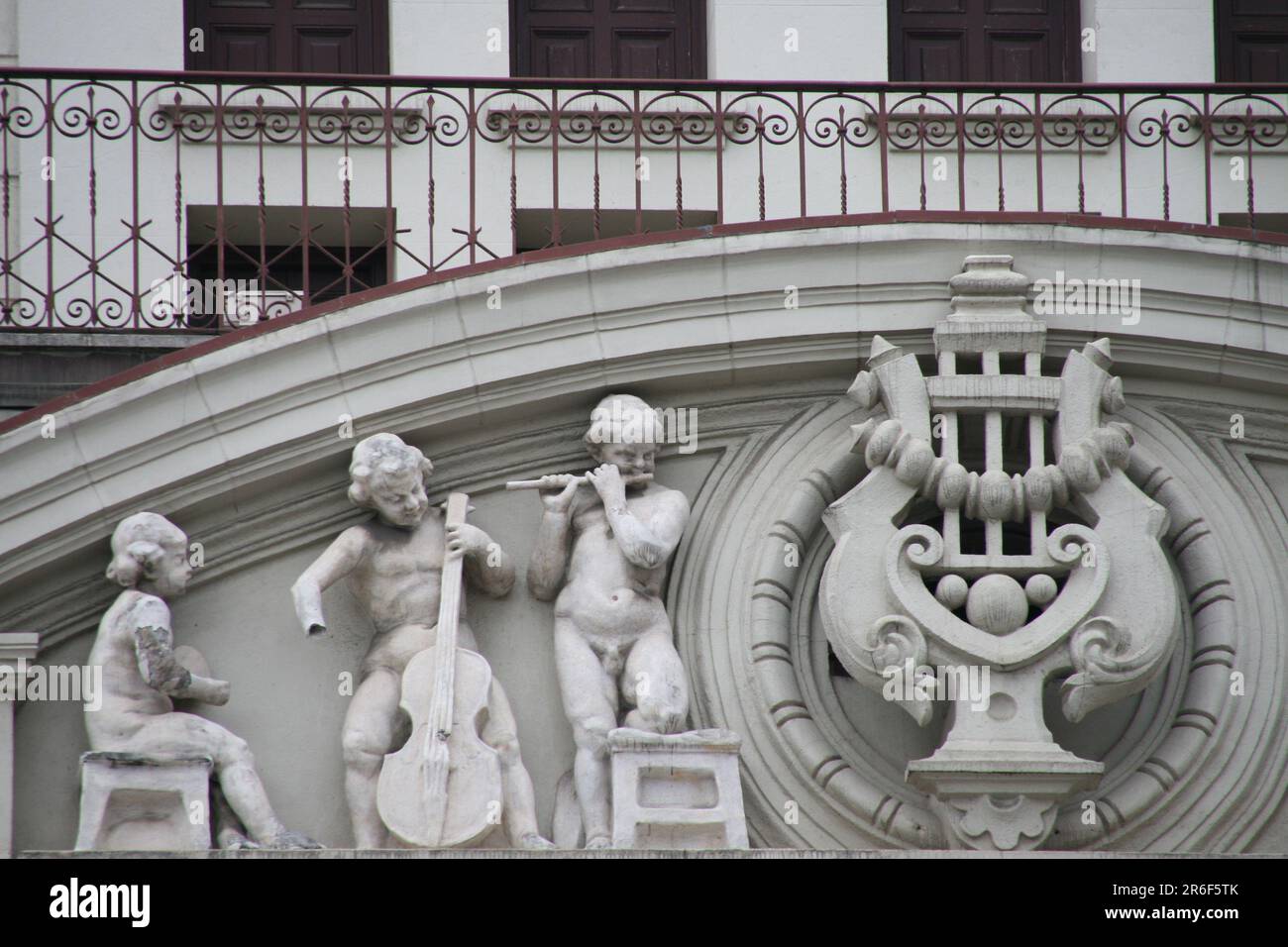 A majestic white building with detailed architectural elements and two ...