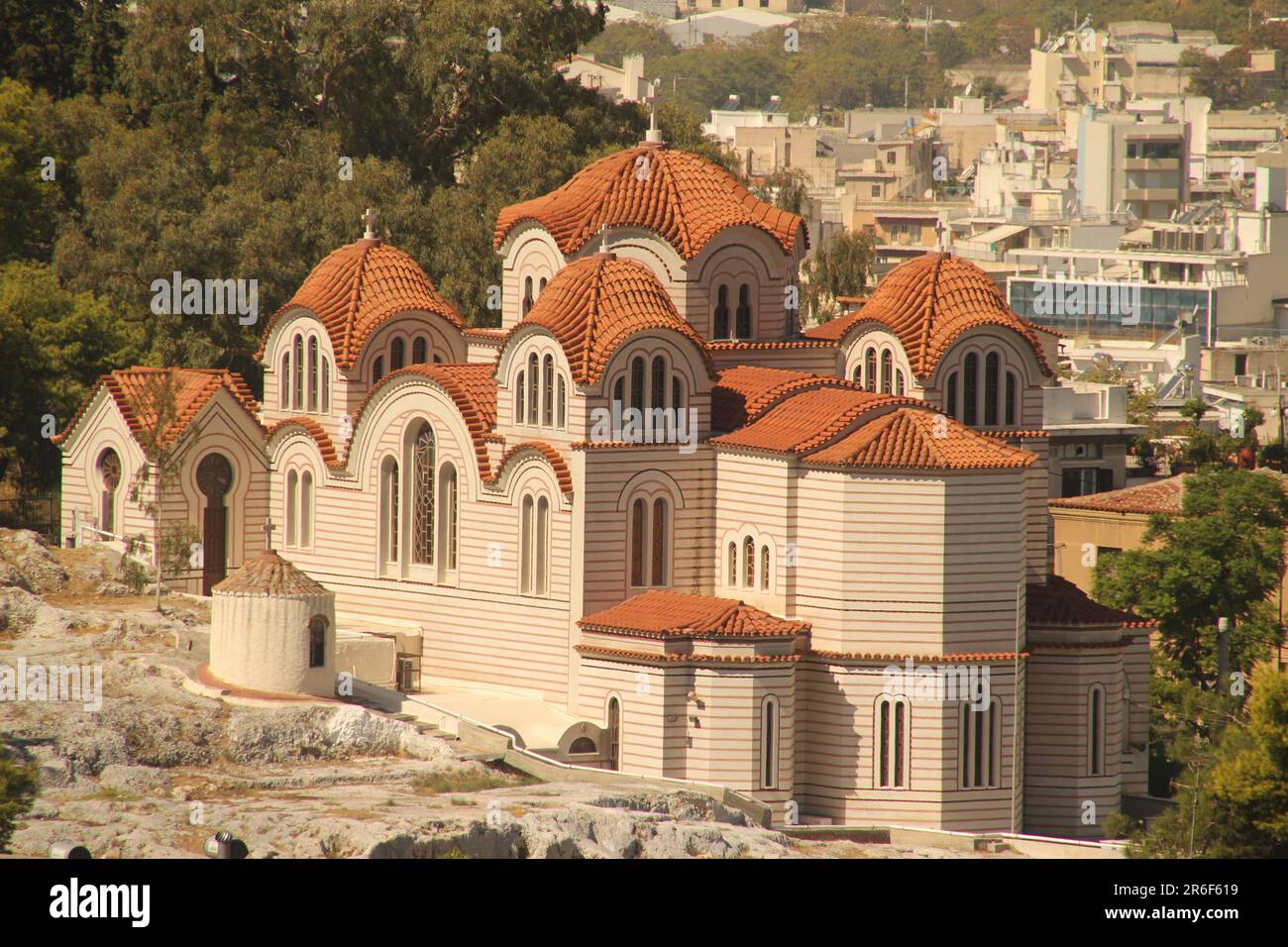 This stunning city skyline showcases a white and red clay building with ...