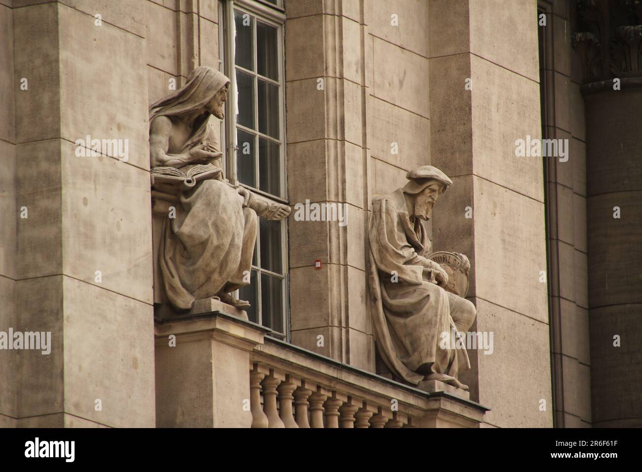 Two ancient statues are visible in an old stone building, placed beside ...