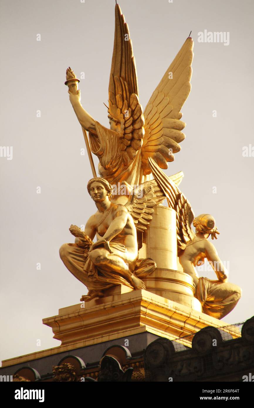 A stunning gold sculpture sits atop a grand architectural structure ...
