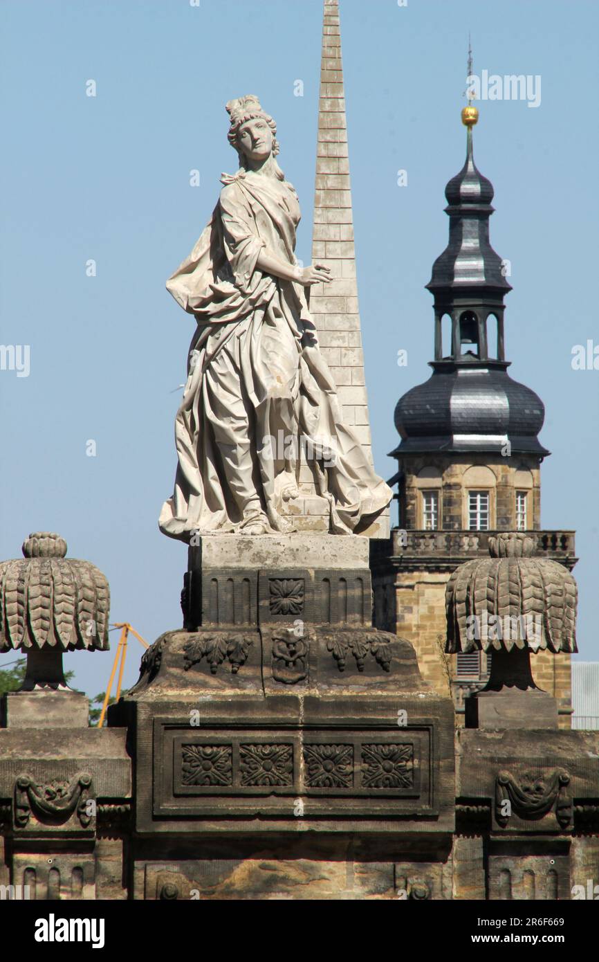A marble statue stands atop a majestic church tower, with the clear ...