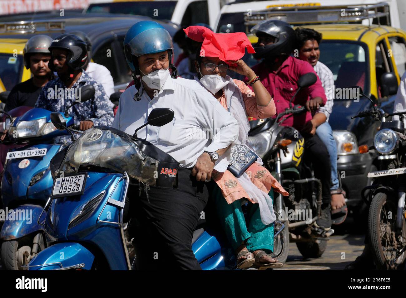A woman shields her face from the sun in Mumbai, India, Friday, June 9 ...