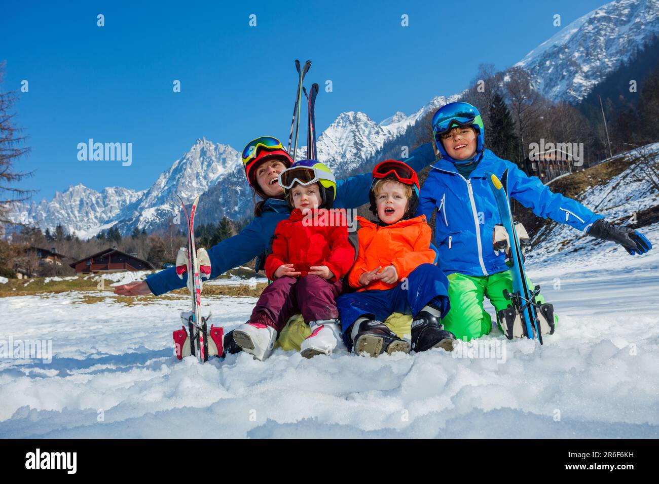 Happy ski vacation with kids mom and children cheer lift hands Stock ...