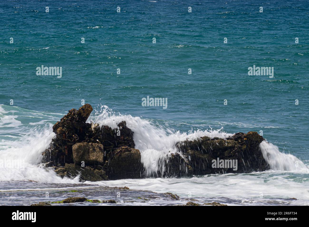 Waves breaking over rocks in the Mediterranean Sea photographed at ...