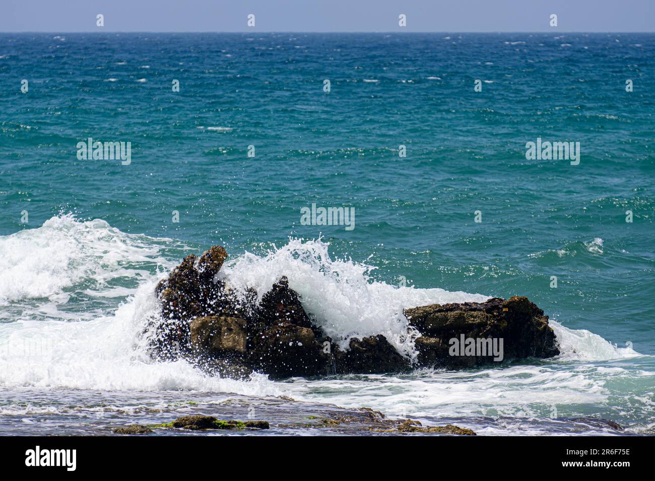 Waves breaking over rocks in the Mediterranean Sea photographed at ...