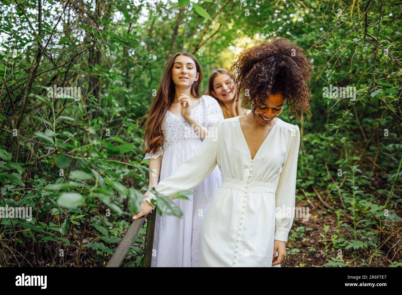 Three happy pretty smiling teenage girls in white summer elegant ...