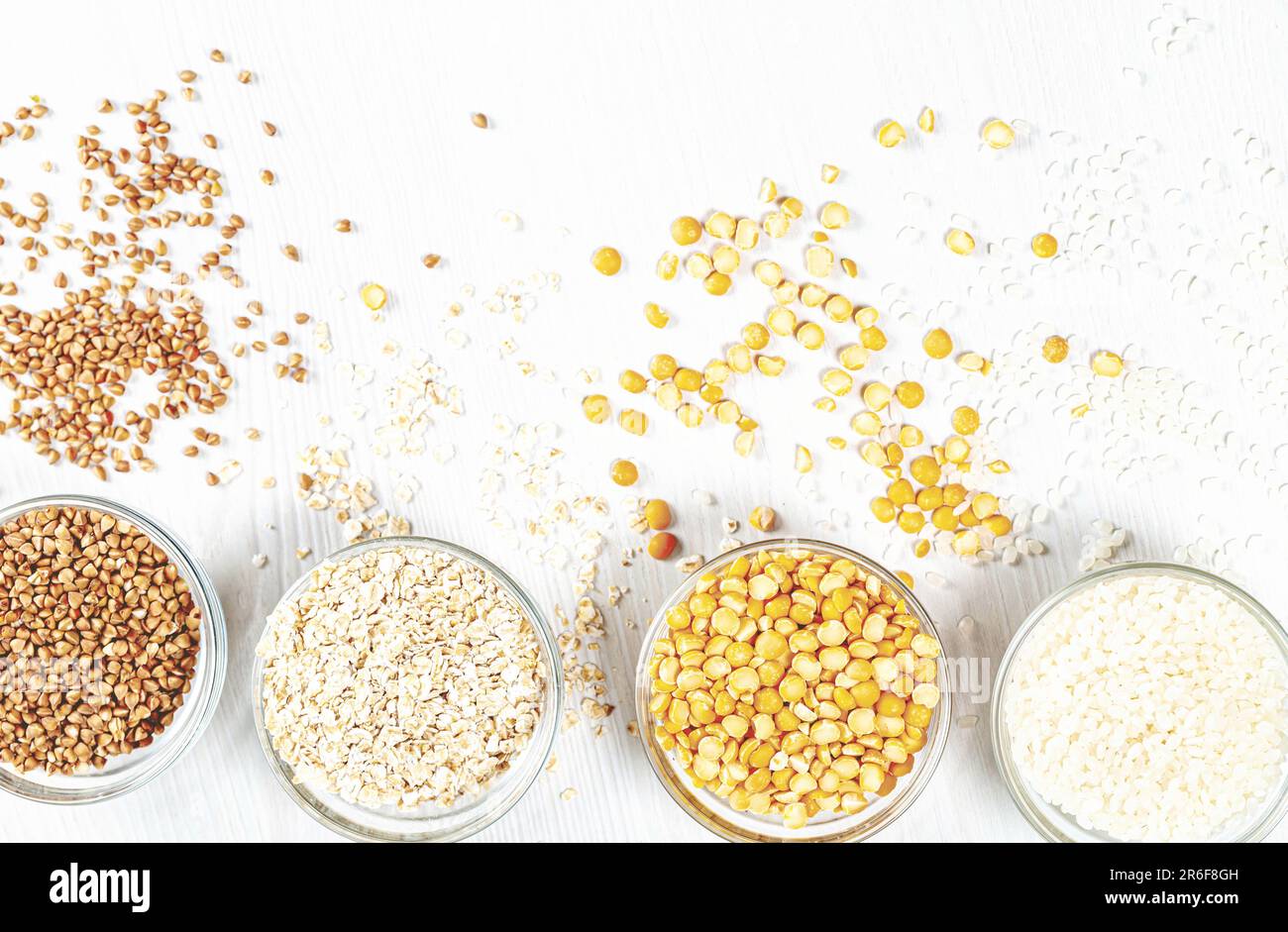 A top view of white rice grains with oats and seeds scattered on the ...