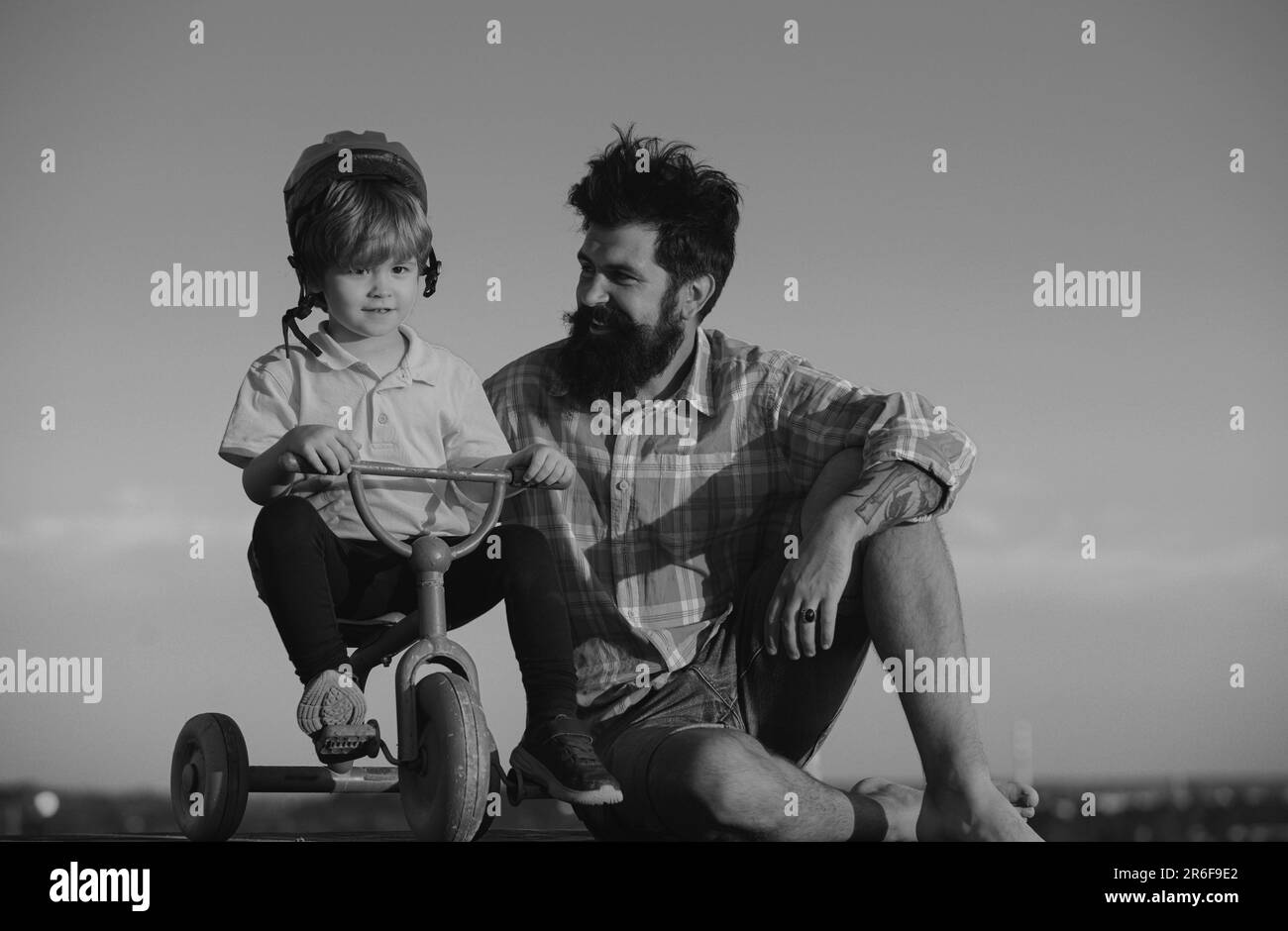Loving family Father and son. Dad help his child ride a bicycle Stock ...