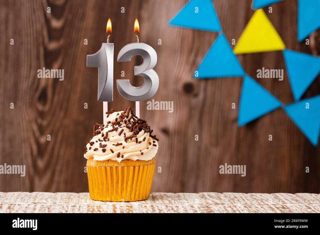 Birthday card with candle number 13 - Wooden background with pennants ...