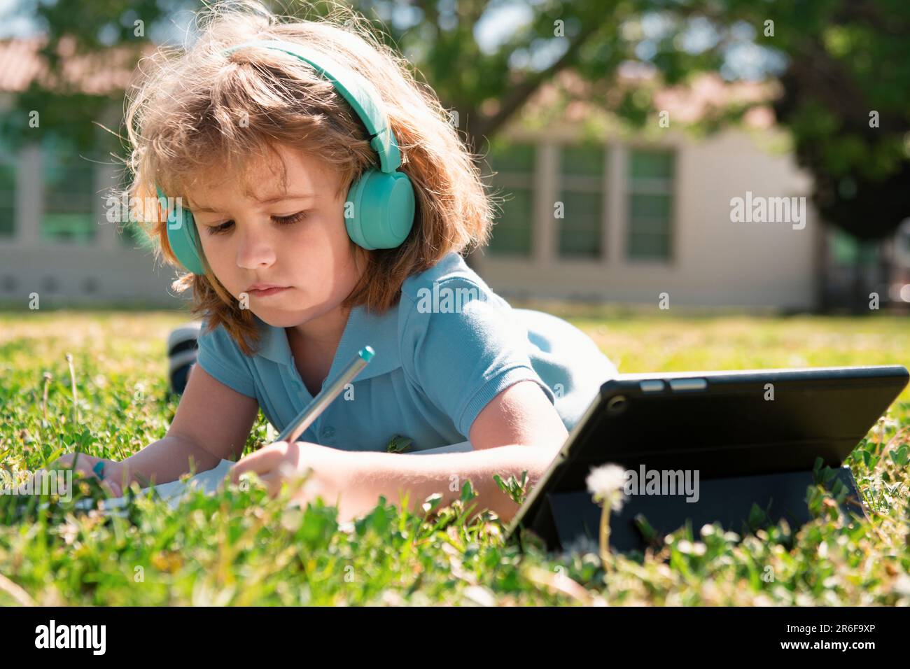 Child homework outside in scholl yard. Little schoolboy pupil with ...