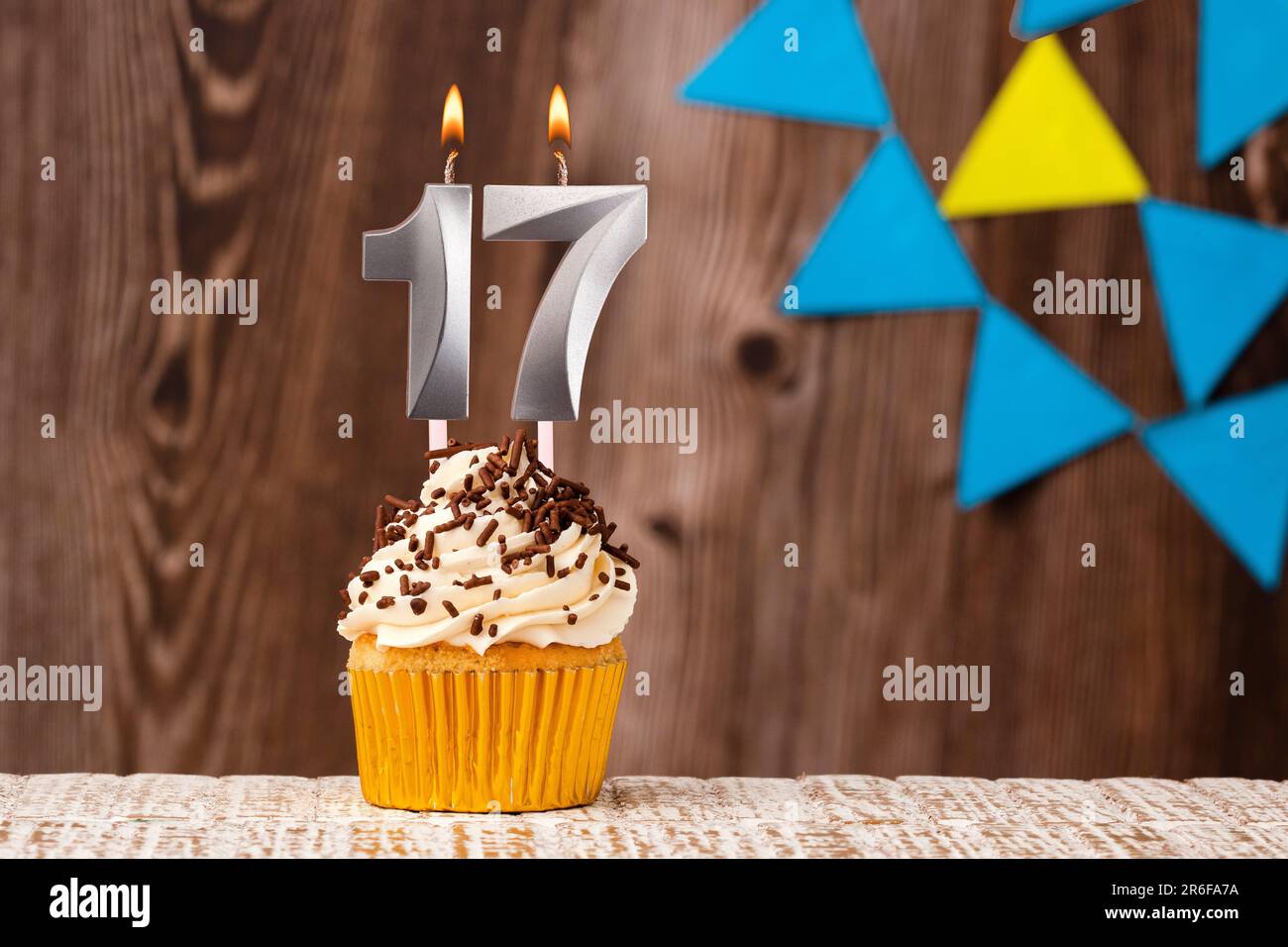 Birthday card with candle number 17 - Wooden background with pennants ...