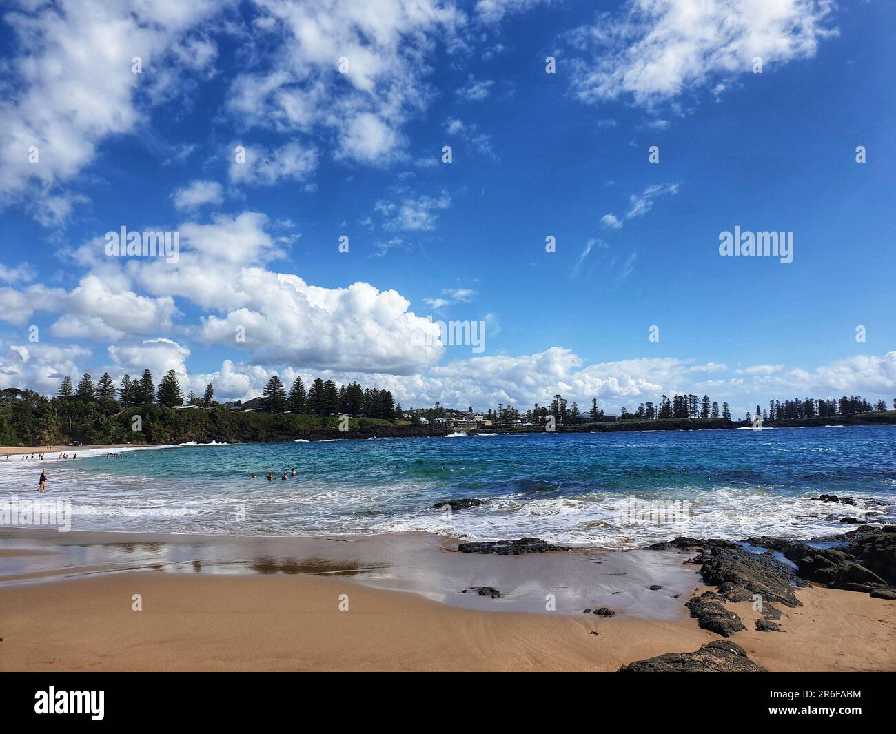 A bright and sunny day at the beach, with the stunning blue water and ...