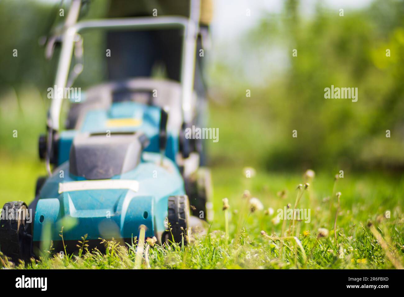 Lawn mover on green grass in modern garden or backyard. Machine for ...