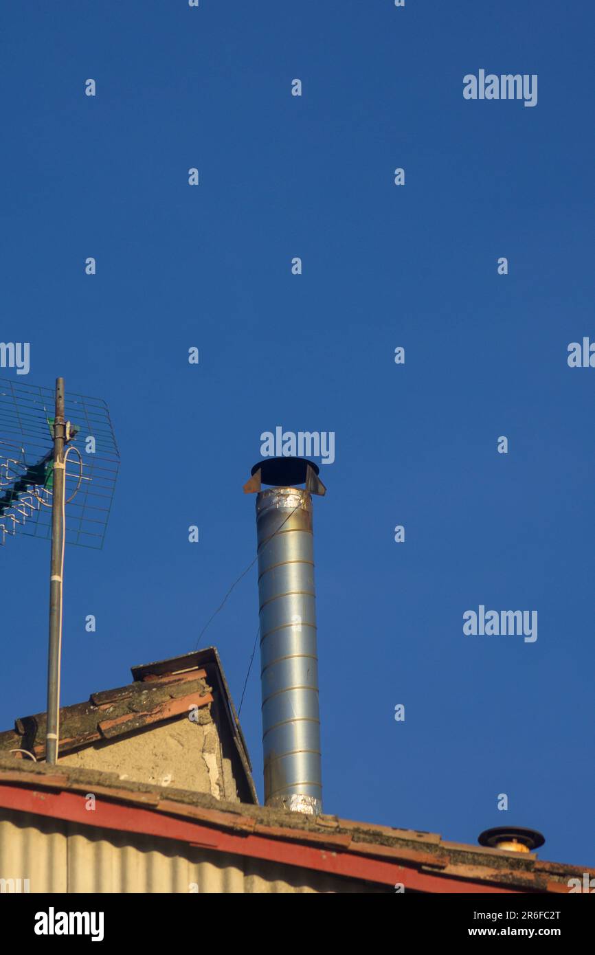 Aluminum chimney for smoke outlet on the roof with blue sky in vertical ...