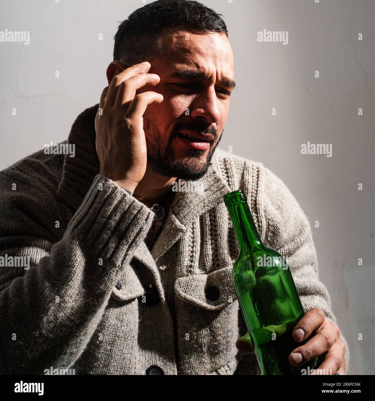 Alcoholic man with bottles wine cry. Depressed crying man. Drunk men ...