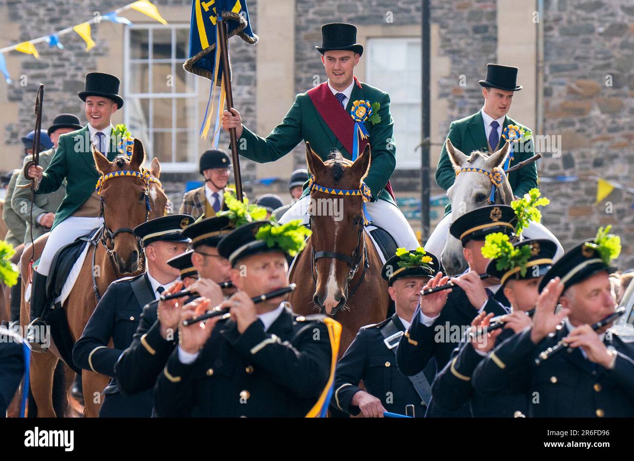 Cornet Euan Robson and his equestrian supporters ride through the town ...