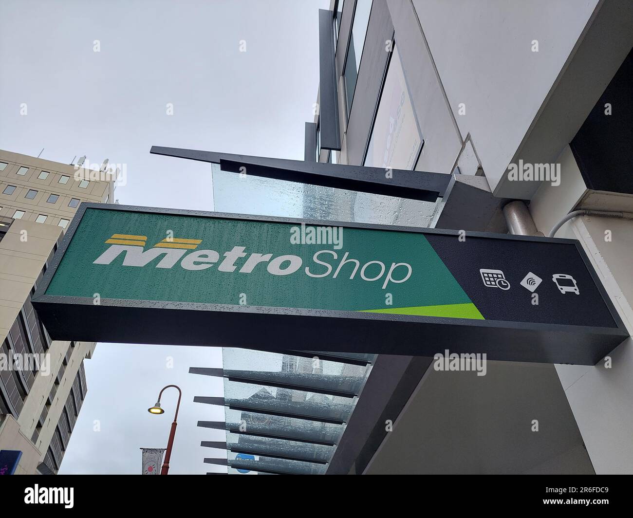 An exterior shot of a retail store, showcasing a logo in the side of ...