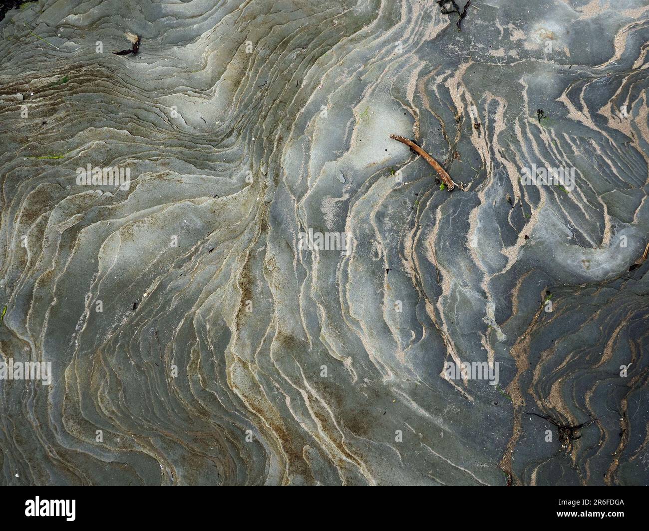 abstract graphic pattern of white sand on eroded blue grey seashore ...