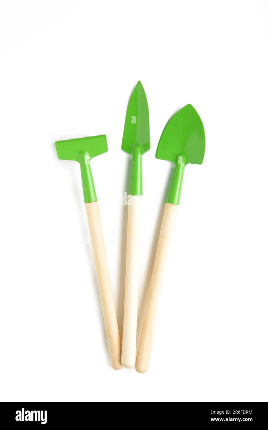 Green gardening tools isolated on white background. Close up. Top view ...