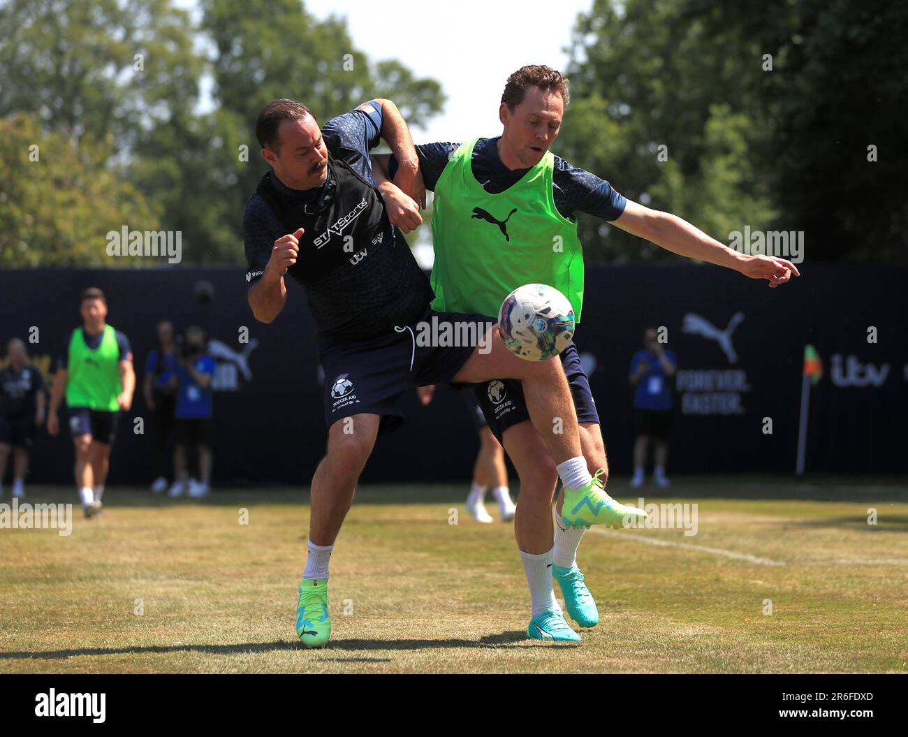 Danny Dyer (left) and Tom Hiddleston battle for the ball during a ...