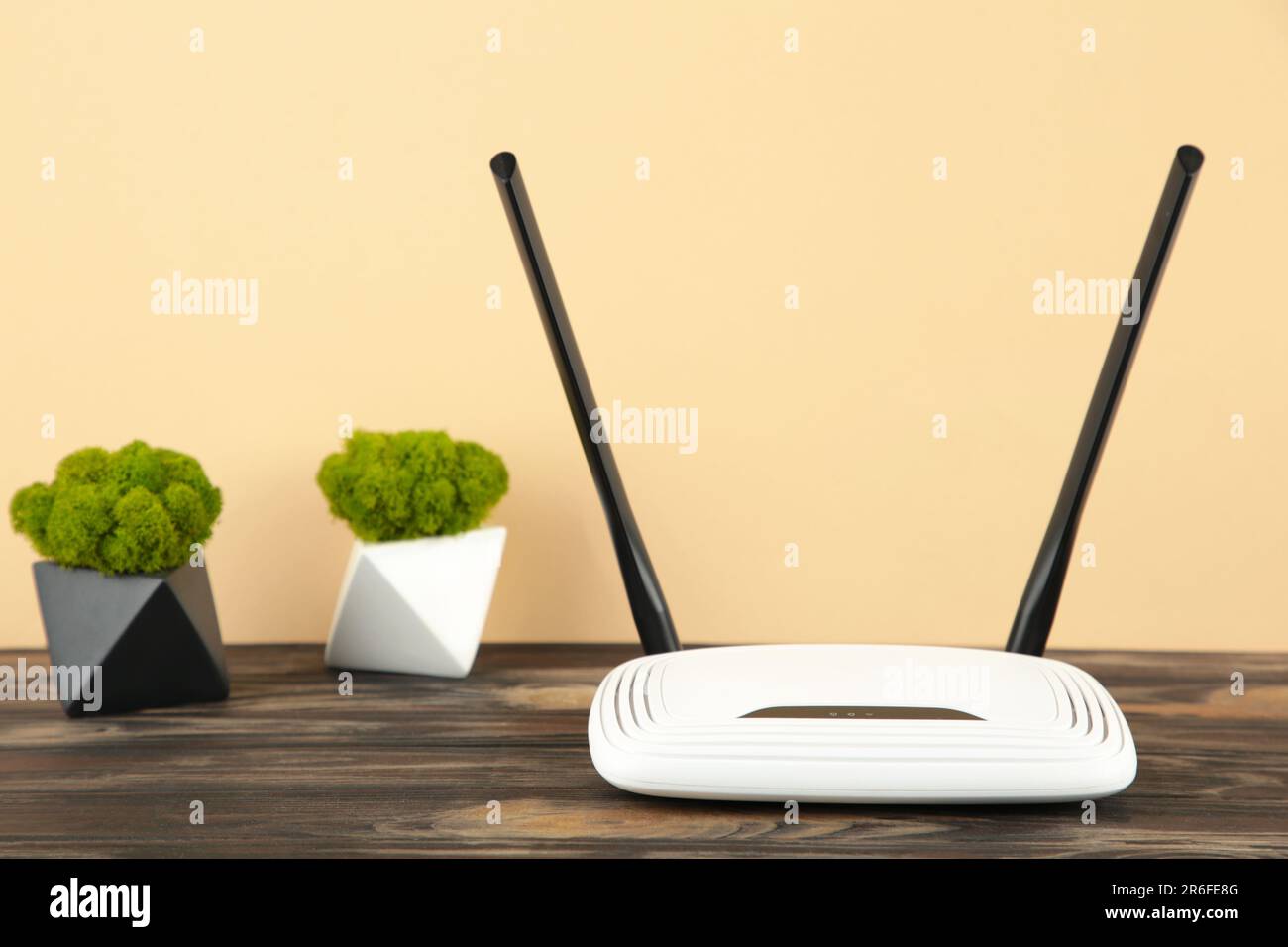 Wireless Wi-Fi router on brown background. Top view Stock Photo - Alamy