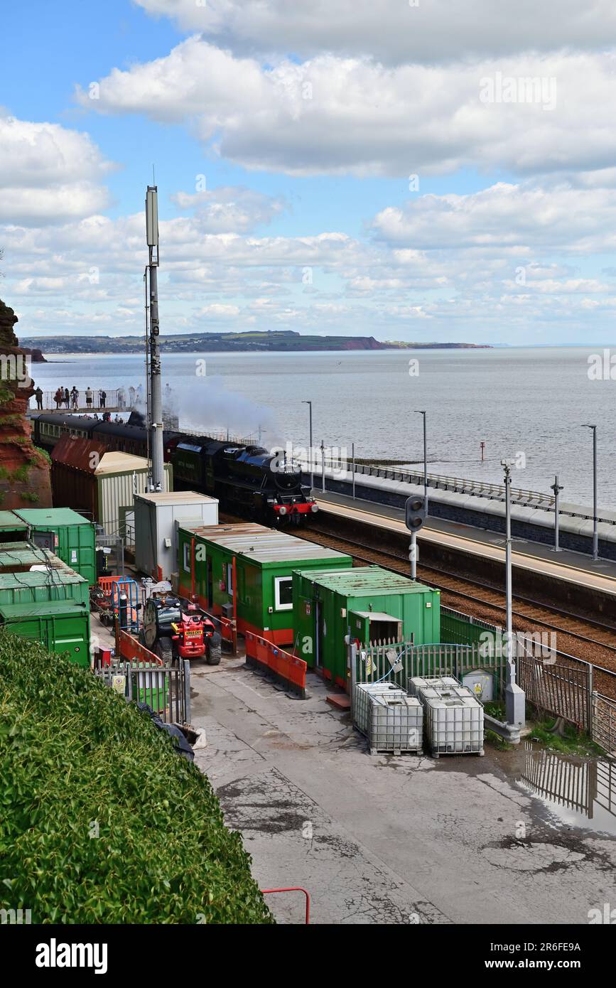 A steam train passing through Dawlish station during building works to ...