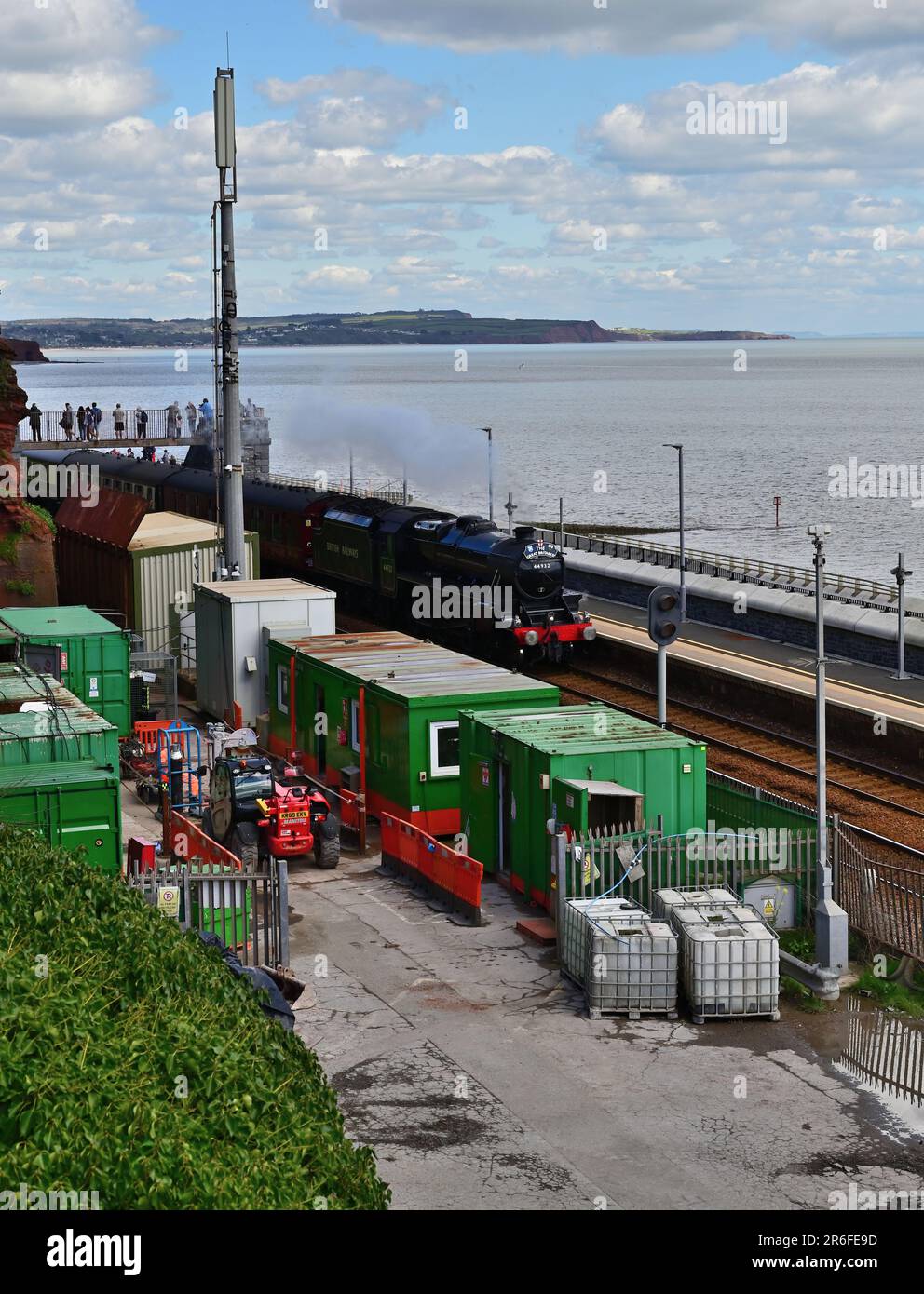 A steam train passing through Dawlish station during building works to ...