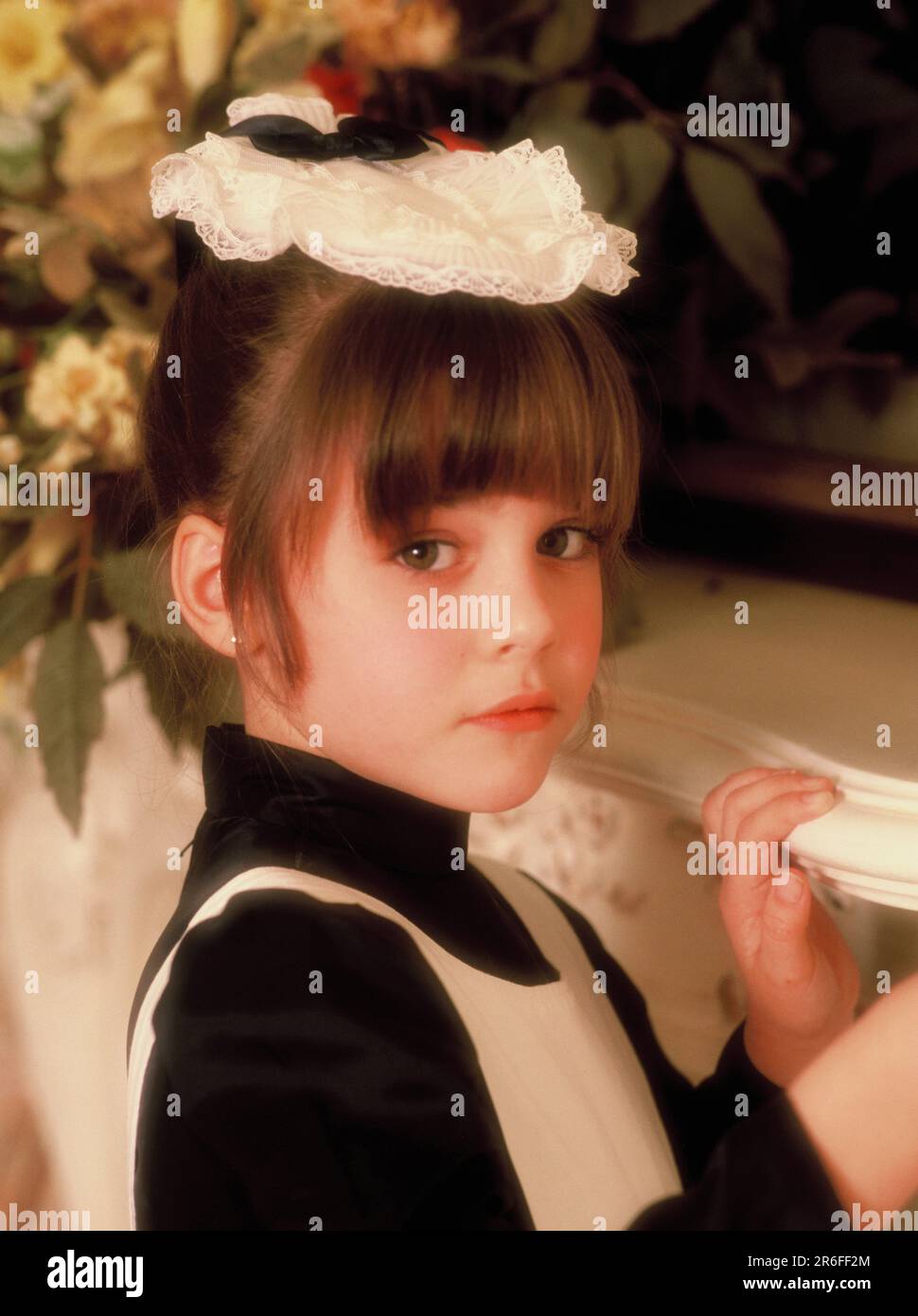 Children. Little girl indoors dressed-up as a French maid Stock Photo ...