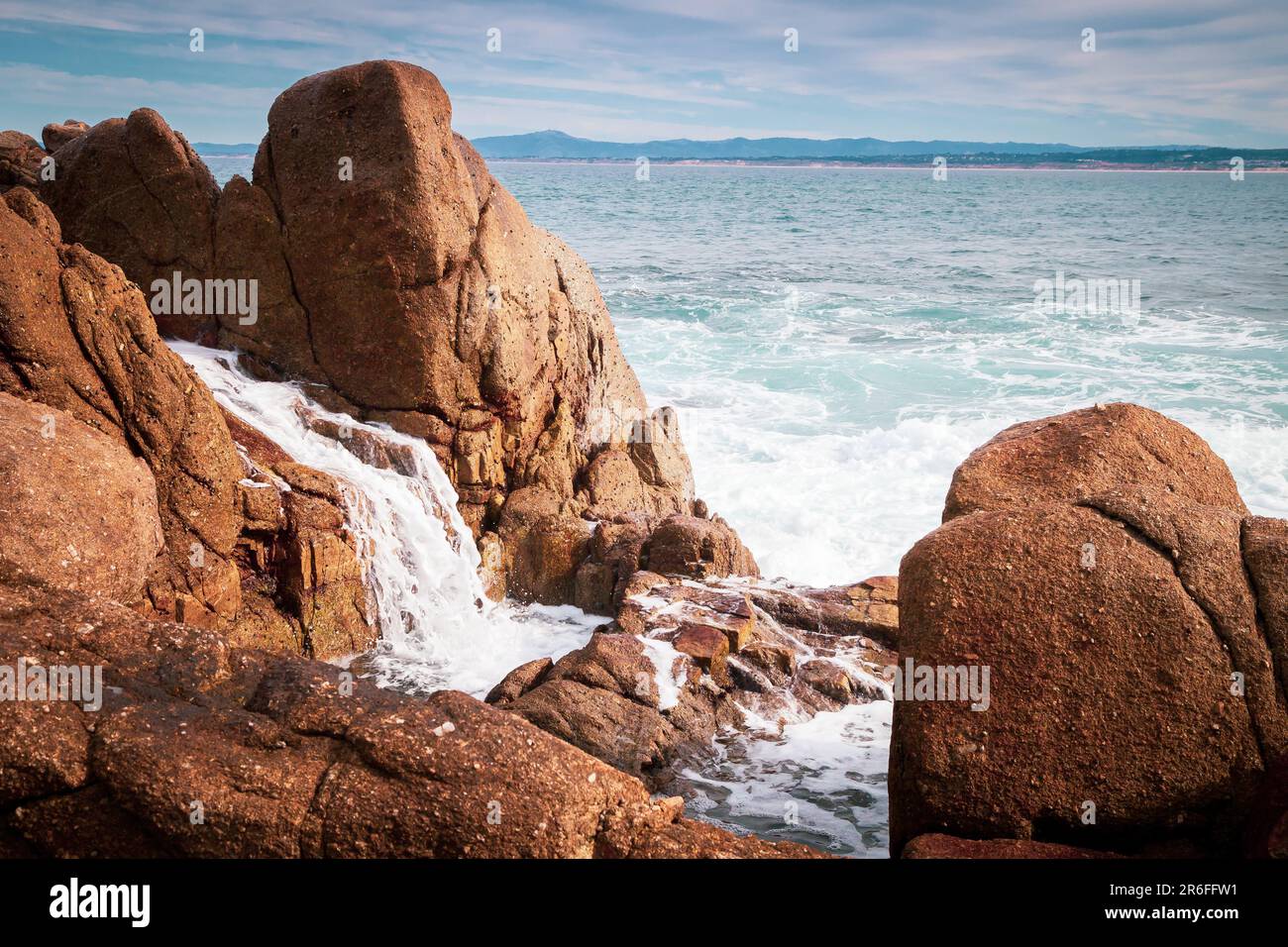 A beautiful view of a shoreline with rock formations and crashing sea ...