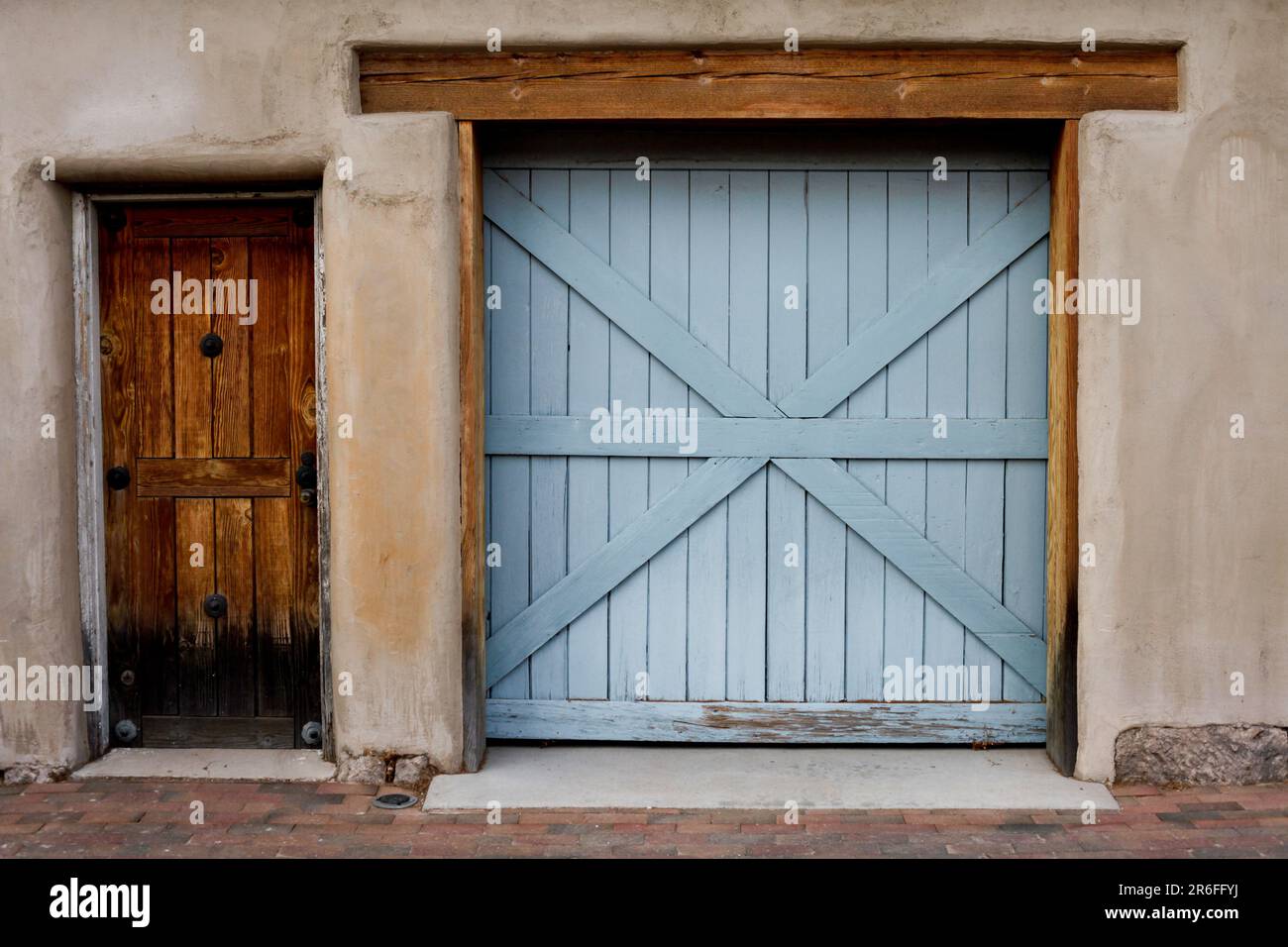 An old building with three doors, two double doors and a wood door ...