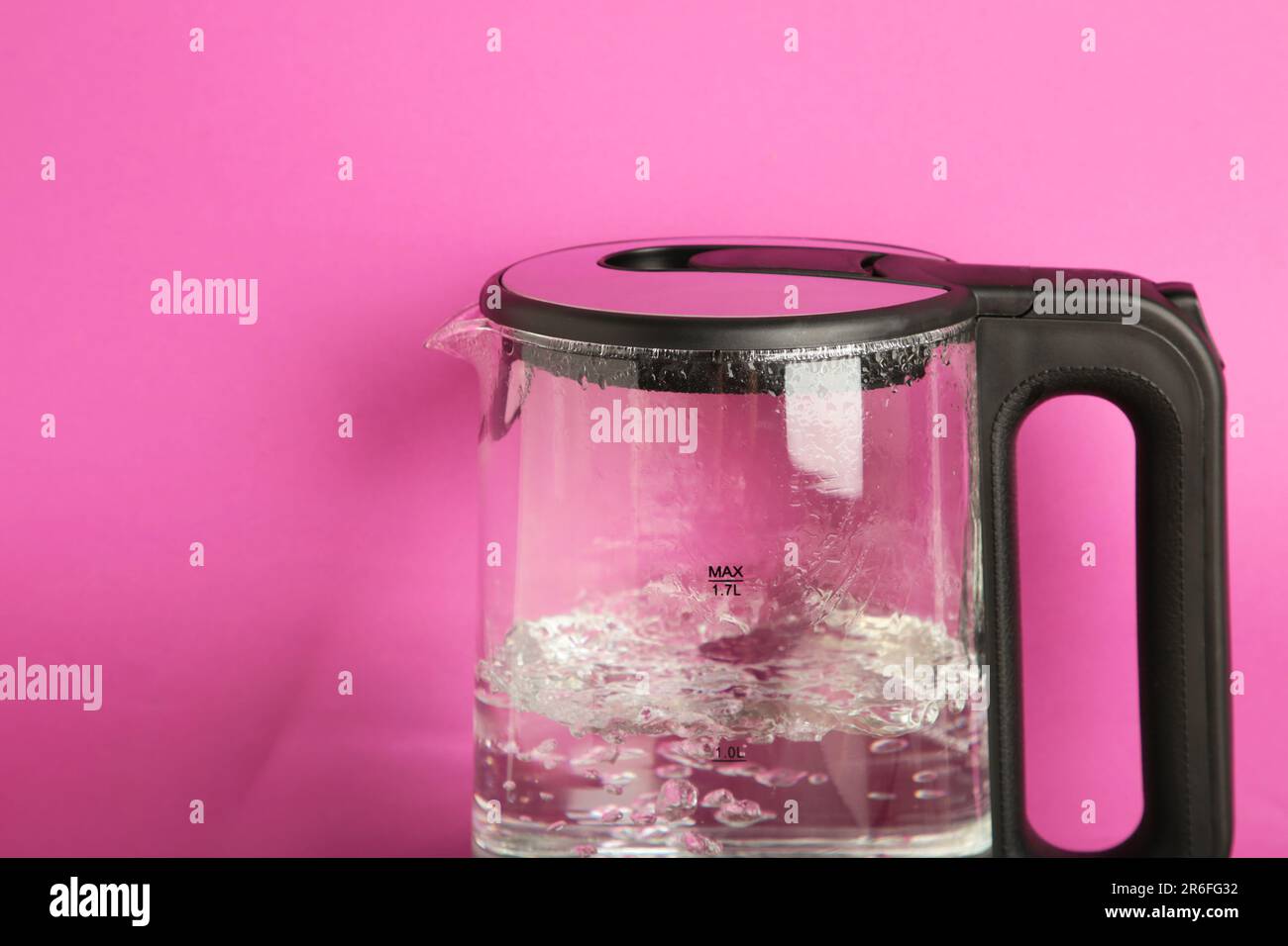 Glass electric kettle with boiling water on pink. Top view Stock Photo ...