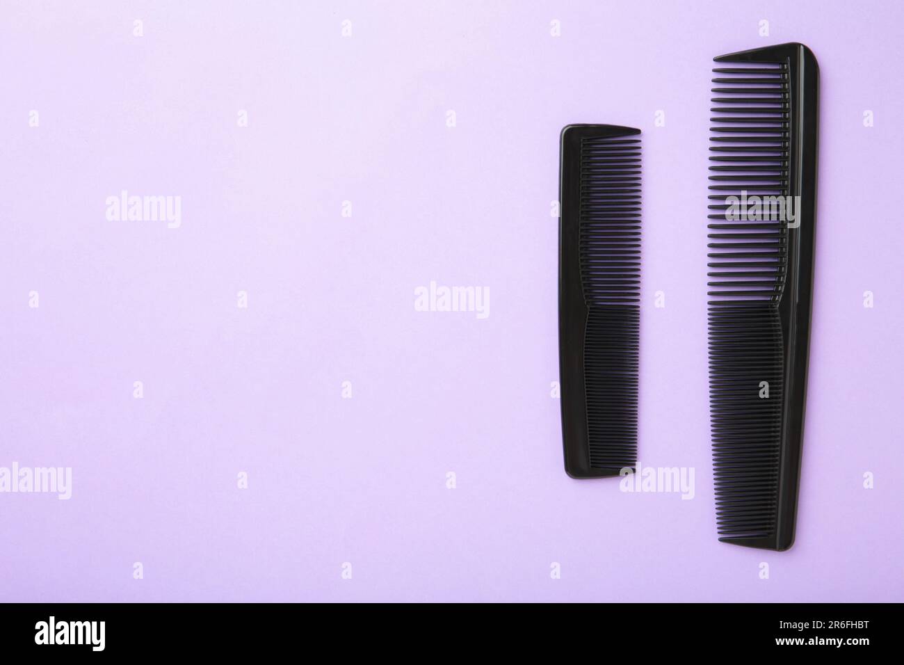 Two comb on a purple background. Device for combing hair. Top view ...