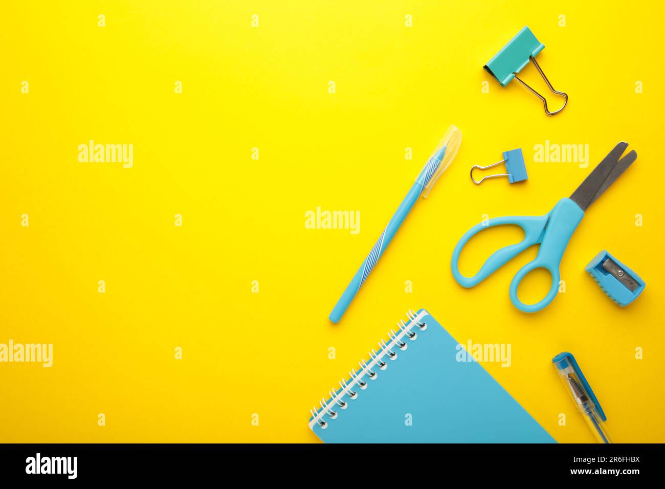 Blue school supplies on yellow background. Back to school concept. Top ...