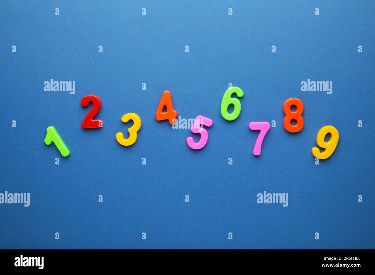 Magnetic multi-coloured figures on a blue background. Back to school ...