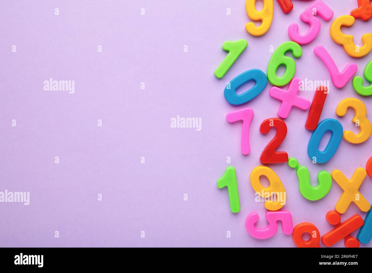 Magnetic multi-coloured figures on purple background. Back to school ...