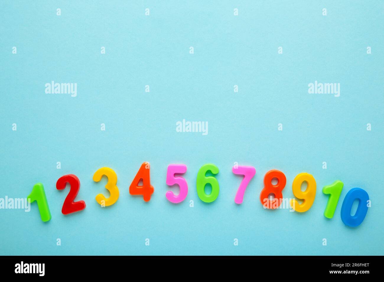 Magnetic multi-coloured figures on a blue background. Back to school ...