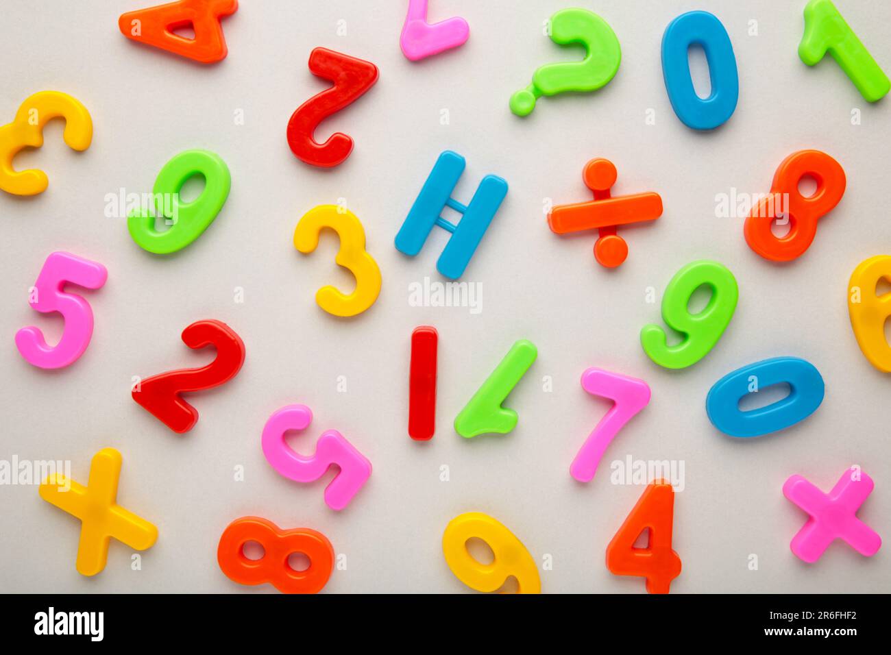 Many colorful numbers on grey background with copy space. Top view ...