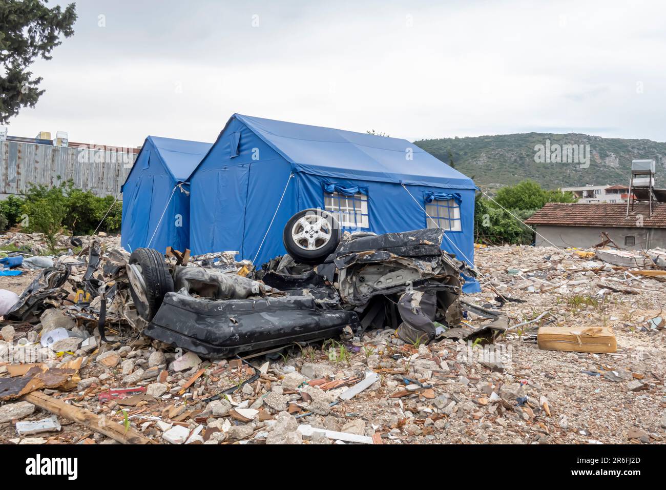 Destroyed car, smashed cars, tents, rubble. Turkish city Antakya in ...
