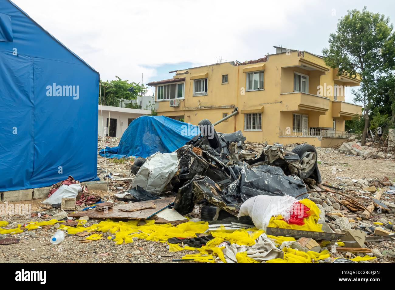 Destroyed car, smashed cars, tents, rubble. Turkish city Antakya in ...