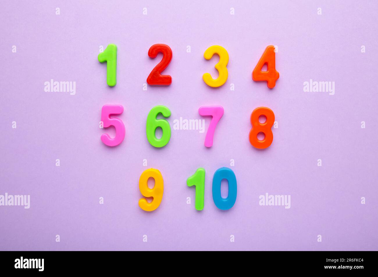 Magnetic multi-coloured numbers on purple background. Back to school ...
