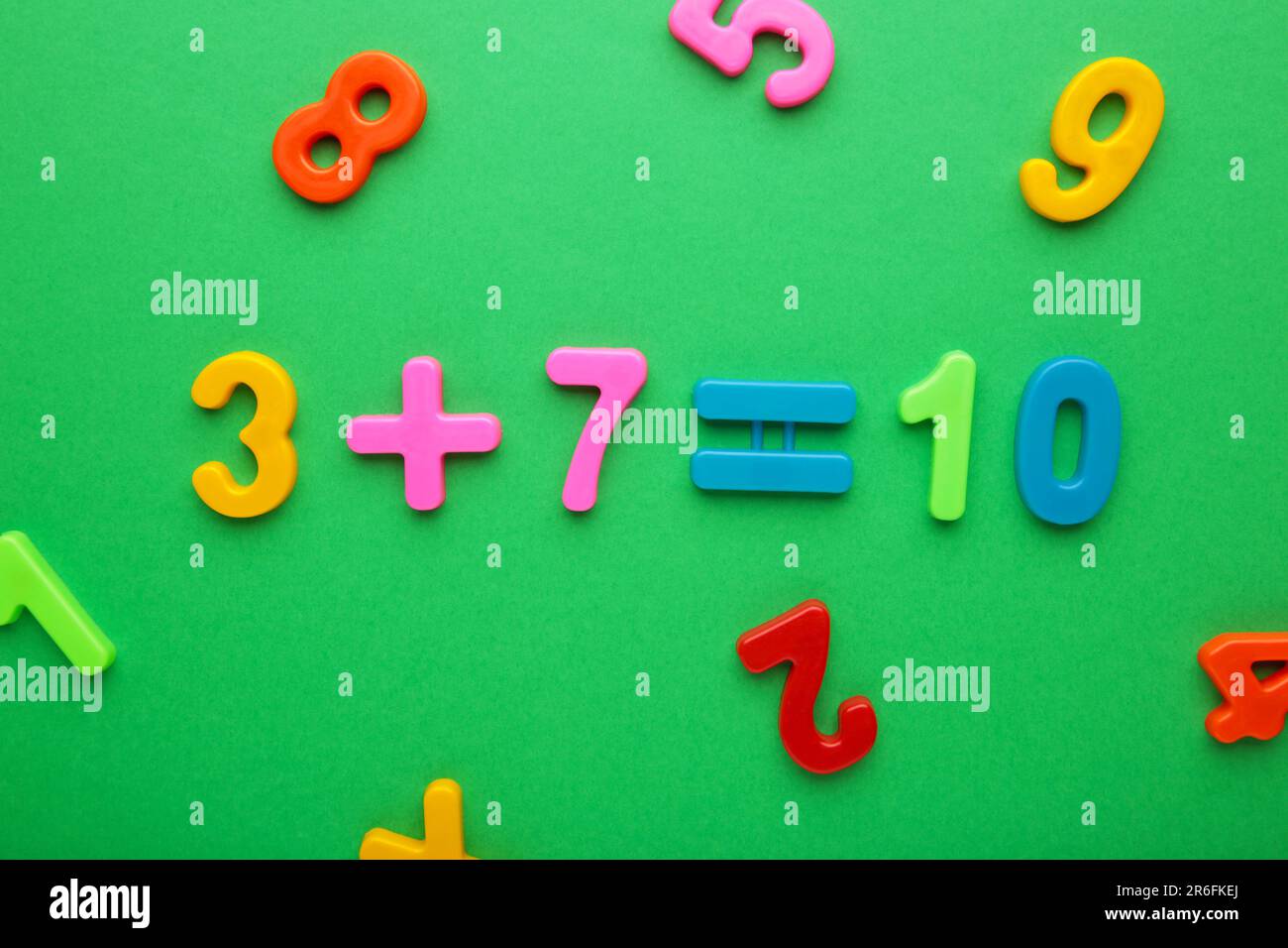 Magnetic multi-coloured numbers on green background. Back to school ...