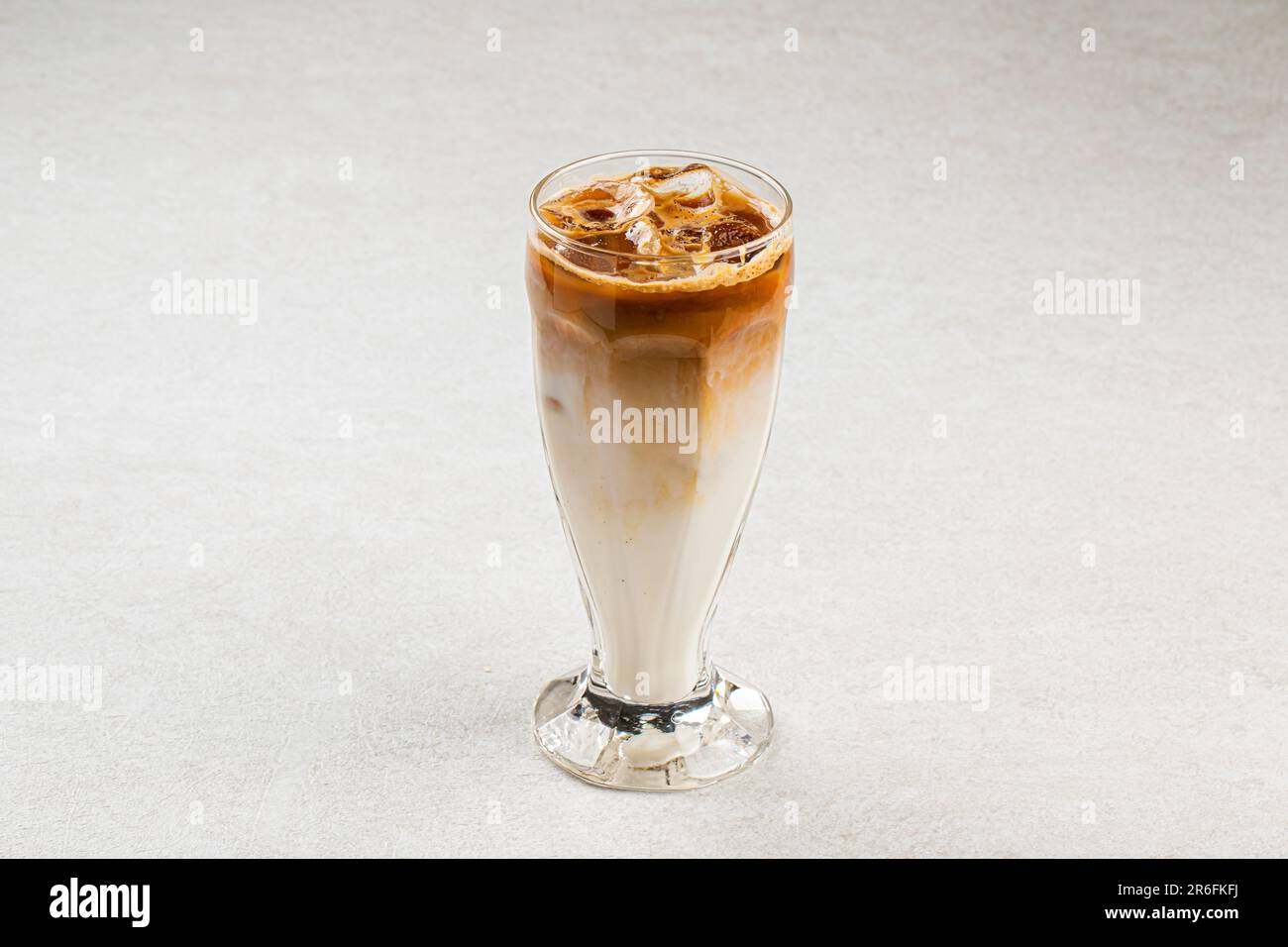 Glass of cold coffee with ice and milk Stock Photo - Alamy