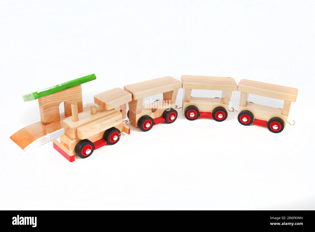 A wooden toy train stops at a station Stock Photo - Alamy